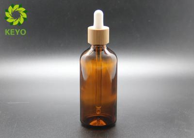 China Boston Round Amber Glass Lotion Bottles With Bamboo Dropper In 30ml 1 Oz for sale