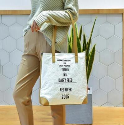 China Washable Kraft Paper Tote Bag with Vest Handles Durable 65lb Capacity Reusable Shopping Bag for sale