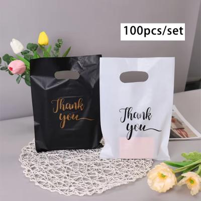 China Medium-thick black clothing gift bag with four-finger flat pocket, moisture-proof, carrying plastic handbag, shoes and socks. for sale