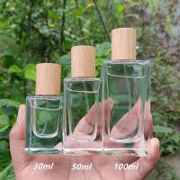 China 30ml 50ml Perfume Spray Bottle Flat Round High End Wood Cap for sale