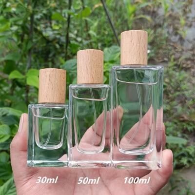 China 30ml 50ml Perfume Spray Bottle Flat Round High End Wood Cap for sale