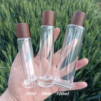 China 100ml Perfume Spray Atomizer Bottle Glass Empty Cylindrical Wooden Lid for sale