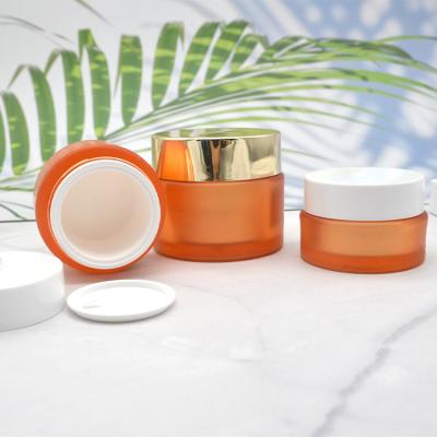 China Gold Amber Cream Frosted Plastic Jars With Aluminium Anodized Caps for sale