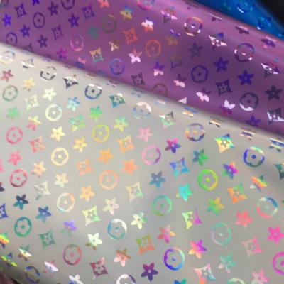 China Laser Colorful Pentagon Flower PU Leather Material 0.8-1.2mm Thickness for Handbags and Clothing for sale