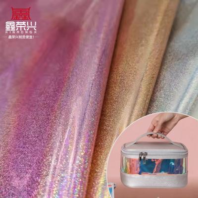 China PU Holographic Leather Little Grain Embossed Synthetic Fabric 0.7mm 140cm for Shoes Handbag Vanity Case for sale