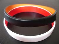 China Custom Two Layer Silicone Wristband 202x12x2mm Dual Color Laser Engraved Bracelet for sale