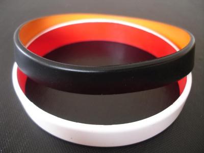 China Custom Two Layer Silicone Wristband 202x12x2mm Dual Color Laser Engraved Bracelet for sale