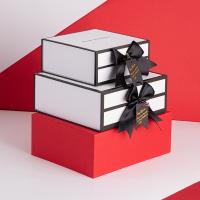 China Rigid White Magnetic Cardboard Gift Boxes With Black Rim And Ribbon Bow for sale