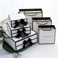 China Rigid White Magnetic Cardboard Gift Boxes With Black Rim And Ribbon Bow for sale