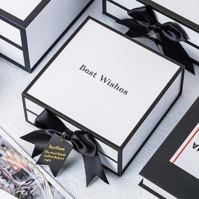 China Rigid White Magnetic Cardboard Gift Boxes With Black Rim And Ribbon Bow for sale