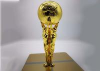 China Shiny Gold Plated Custom Trophy Cup With The Statue Holding The Ball Design for sale