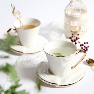 China Custom Gold Plated Ceramic Cup with Saucer 200ml Wholesale Modern Irregular Coffee Tea Cups for sale