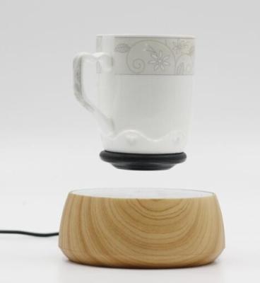 China 360 rotating magnetic floating bottom coffee cup water cup for sale