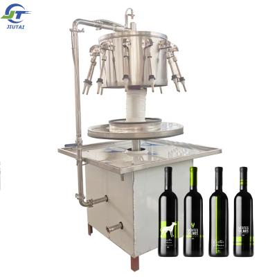 China 12 Head Rotary Semi Automatic Beverage Alcohol Wine Glass Bottle Liquid Filling Machine for sale