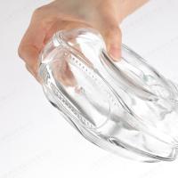China Customized Color 500ml 700ml 750ml Flat Round Glass Bottle for Beverage Packaging for sale