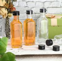 China 750ml Round Olive Oil Glass Bottle with Customized Black Screw Cap and Transparent for sale