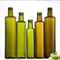 China Body Material Glass Olive Oil Bottle Dark Green Round Oil Glass Bottle with Metal Lid for sale