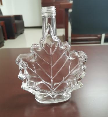 China High Borosilicate 25cl Leaf Shape Spirit Glass Bottle With Screw Cap for sale