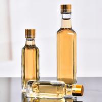 China Glass Olive Oil Bottle 100ml 250ml 500ml Round Clear Cooking Oil Bottle with Cap for sale