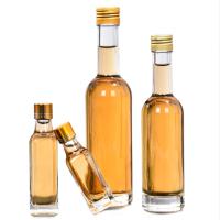 China Glass Olive Oil Bottle 100ml 250ml 500ml Round Clear Cooking Oil Bottle with Cap for sale