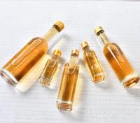 China Glass Olive Oil Bottle 100ml 250ml 500ml Round Clear Cooking Oil Bottle with Cap for sale