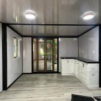 China 20ft Expandable Container Home 38.2sqm Red Wooden Color Black Frame Hydraulic Expansion System for sale
