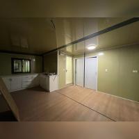 China 20ft Expandable Container House with Stone-Texture Cladding and Dark Grey Frame for sale
