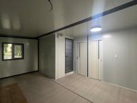 China 20ft Expandable Container House with White Cladding, Black Frame and Glass Entrance Doors for sale
