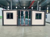 China 20ft Expandable Container House with White Cladding, Black Frame and Glass Entrance Doors for sale