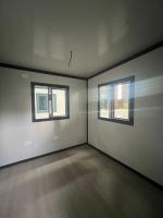 China 20ft Expandable Container House with White Cladding, Black Frame and Glass Entrance Doors for sale