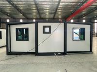 China 20ft Expandable Container House with White Cladding, Black Frame and Glass Entrance Doors for sale
