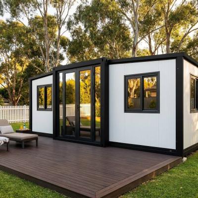 China 20ft Expandable Container House with White Cladding, Black Frame and Glass Entrance Doors for sale