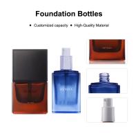 China Luxurious Blue Frosted Glass Foundation Empty Bottle With Pink And Purple Caps for sale