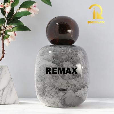 China 100ml Round-Top Glass Perfume Bottle with Elegant Marble Pattern for Luxury Fragrances for sale