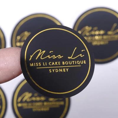 China Luxury Gold Foil Stamp Stickers Black Round Custom Printing Logo Stickers for sale