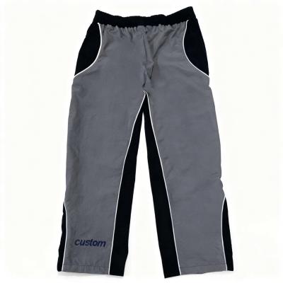 China Oem Custom Casual Nylon Windbreaker Embroidery Men'S Pants Streetwear Wide Leg Pockets Polyester Track Pants for Men for sale