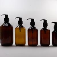 China Round Amber Cosmetic Bottles 50ml 200ml 250ml PET Container with 0.35ml Discharge Rate for Shampoo and Lotion for sale