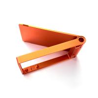 China CNC Machined 6061-T6 Aluminum Foldable Phone Stand Housing Orange Anodized Magnetic Wireless Charger Enclosure for sale
