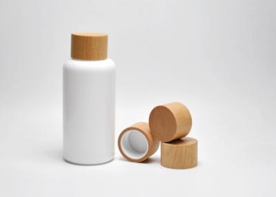 China Sustainable 100ml Boston Round Opal White Glass Lotion Bottles With Wooden Screw Cap, Primary Cosmeceutical Packaging for sale