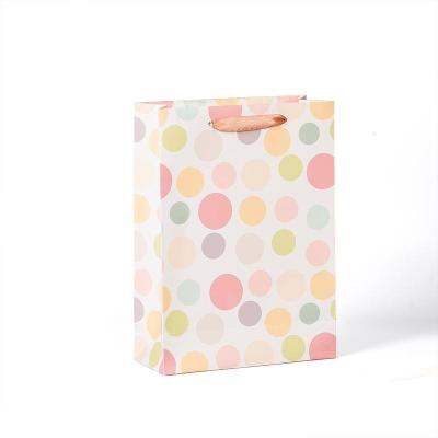 China Luxury Custom Logo White Kraft Paper Gift Bags - Eco-Friendly & Stylish For Clothing Brands for sale