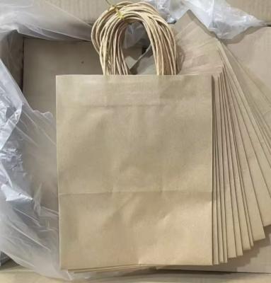 China Shopping tote bag with twisted handles made of white and brown kraft paper, printed with a logo for sale