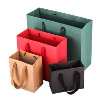 China Luxury Small Business Gift Bag Handmade Kraft Paper Packaging With Ribbon Handles For Promotion Black Color for sale