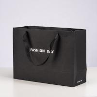 China Black Handmade Paper Gift Clothes And Bags Wrapping Creative Customised Embossed Texture Luxury Cardboard Paper Bag Logo Black for sale