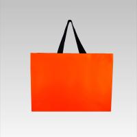 China Luxury Durable Eco-Friendly Art Paper Shopping Gift Bag with Ribbon Custom Logo Debossed Gold Stamp Drawstring Handles Orange for sale