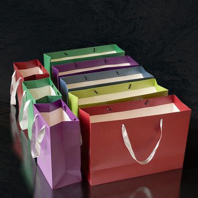 China Custom Logo Luxury Recyclable Kraft Paper Ribbon Handles UV Printed Jewelry Handbag Cosmetics Clothing Shopping Promotion for sale