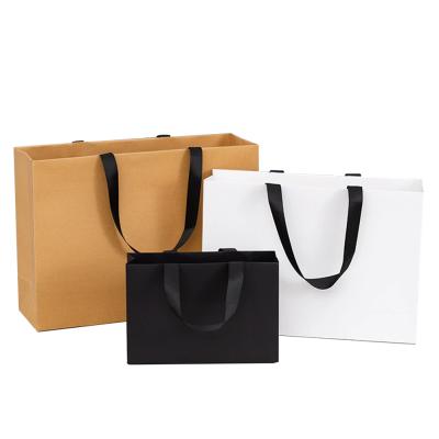 China Handmade Kraft Paper Bag Tote Bag With Thread Rope For Clothing Candles And Crafts Gravure Printing In Stock for sale