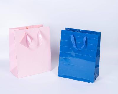 China Luxury Recyclable Kraft Paper Gift Bags Custom Printing Unique Design Wedding Gift Bags With Ribbon Handles Gold Foil Christmas for sale