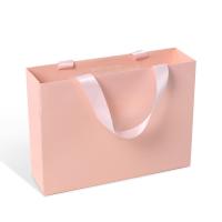 China Economic Printed Design Custom Art Paper Glossy Pink Paper Shopping Bags With Ribbon Handle for sale