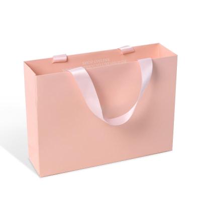 China Economic Printed Design Custom Art Paper Glossy Pink Paper Shopping Bags With Ribbon Handle for sale