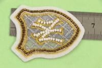 China Stylish Silver Gold Metallic Embroidery Badge With White Felt Ground Beads Around For Caps Shoes for sale
